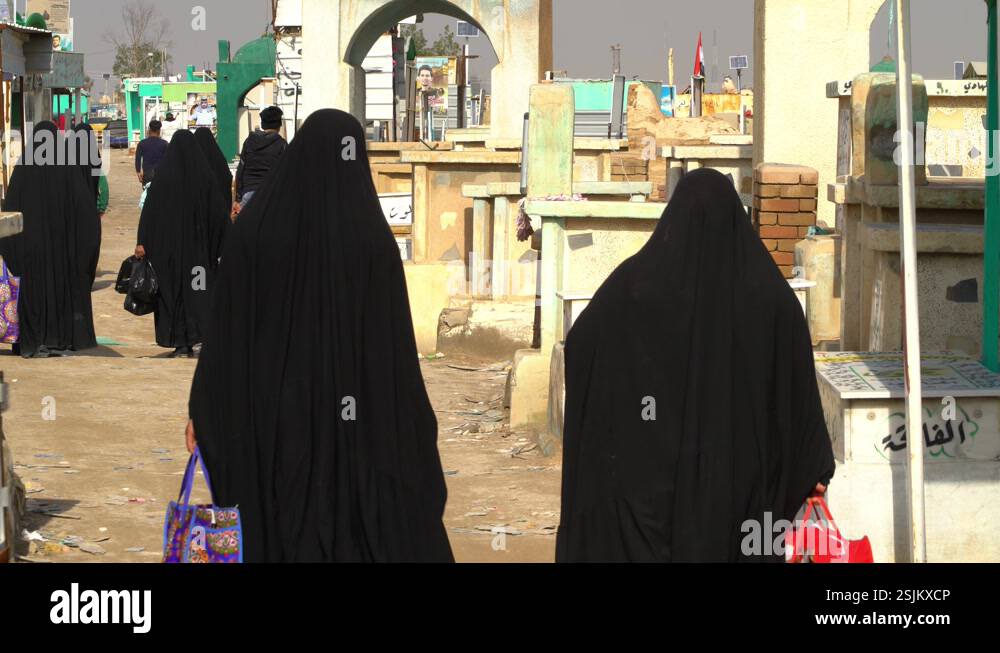 Back view of women wearing black Burqa in Islamic Cemetery, Najaf in ...