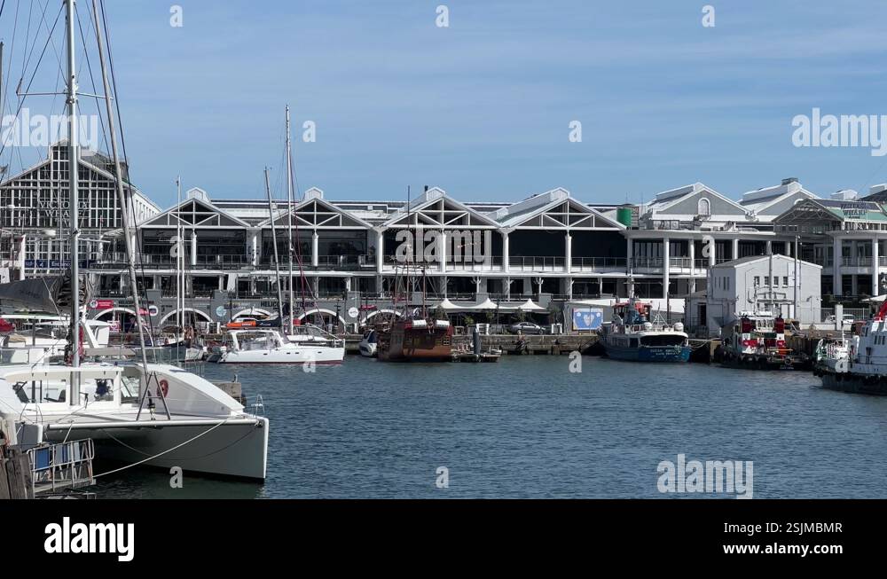 Victoria Wharf waterfront mall with boats and catamaran in the harbour ...