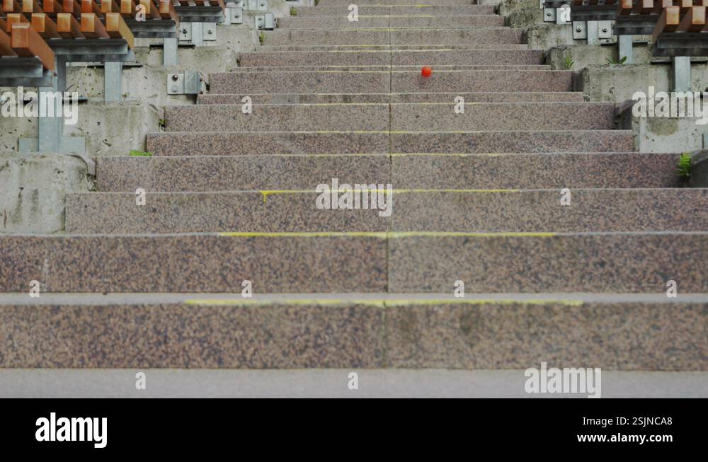 Red ball rolling down the steps of an amphitheater Stock Video Footage ...