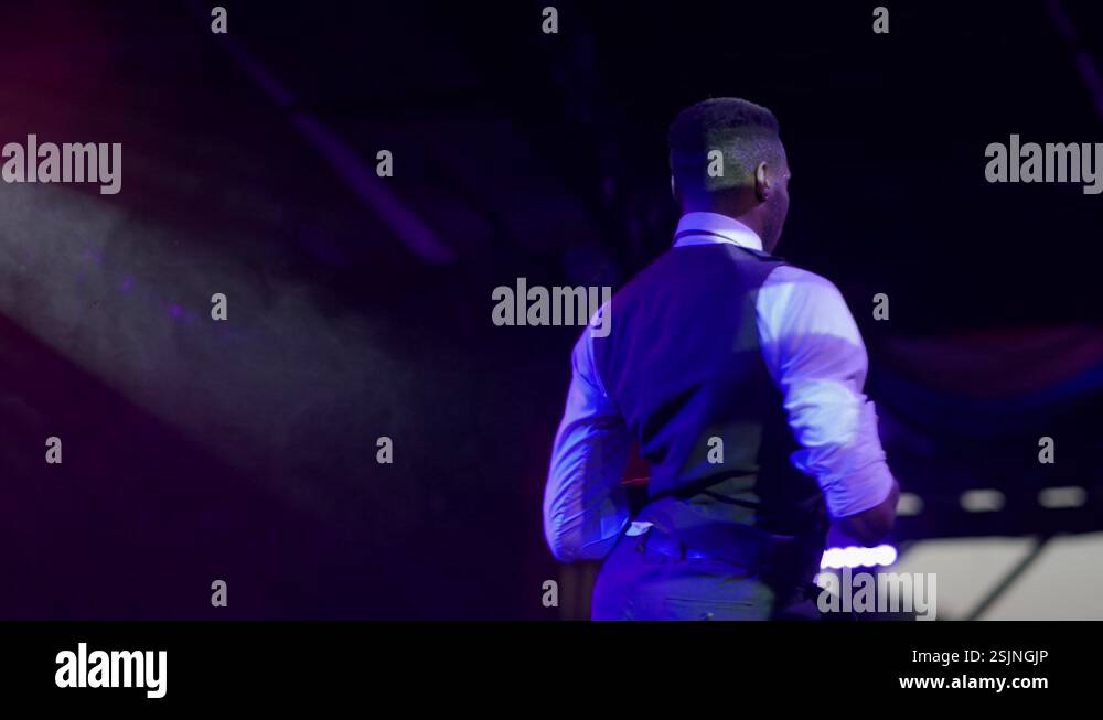 Back view of a black man performing on stage with the suit Stock Video ...