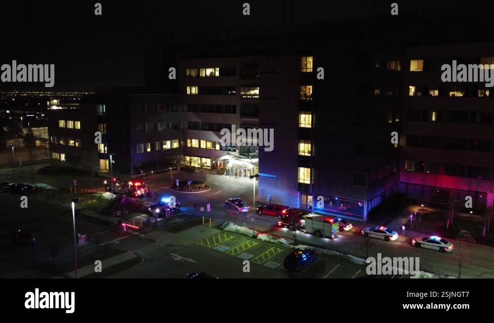 Fire Trucks And Police Cars Flashing Lights At Night In Front Of A ...
