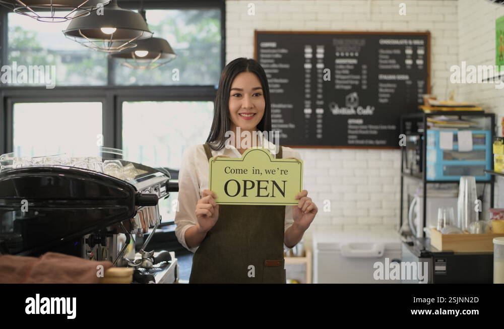 Coffee shop concept of 4k Resolution. Asian women are holding signs to welc Stock Video Footage ...