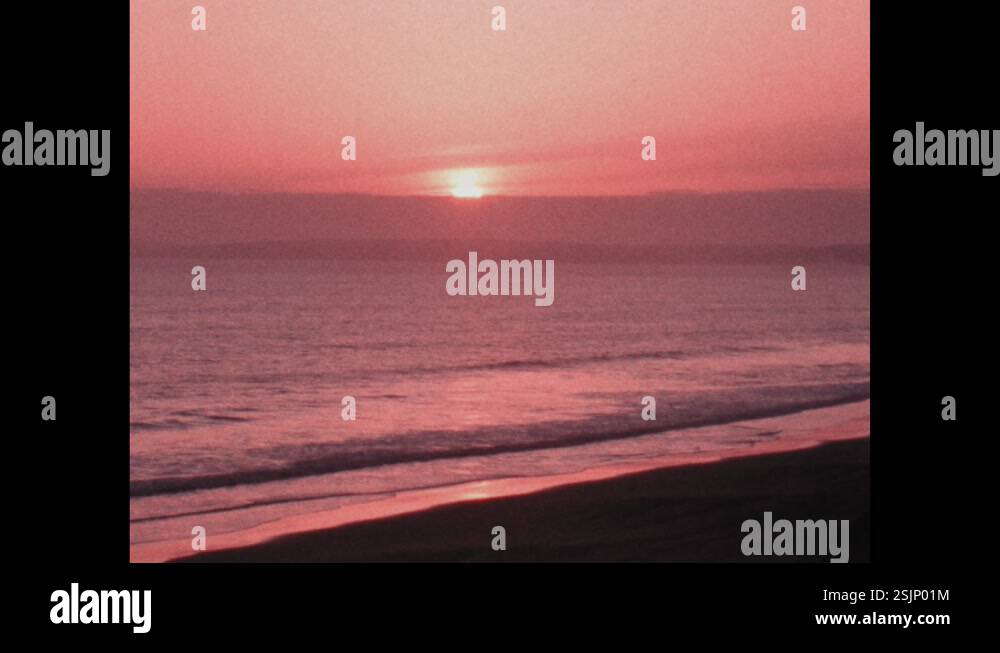 1980s: Sun sets on ocean. Silhouette of family watching sunset from ...