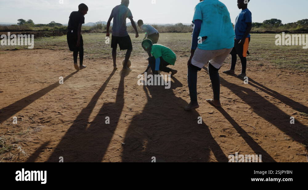 Poverty. Slow motion. Poor Black African children playing soccer in a ...