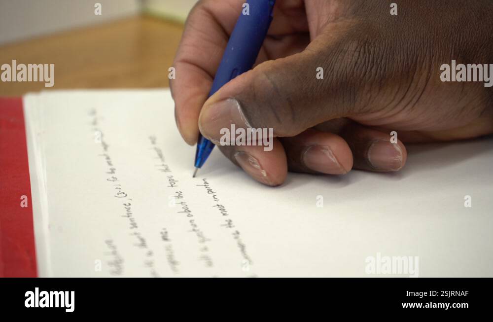 close up african american writing in prison black inmate in jail ...