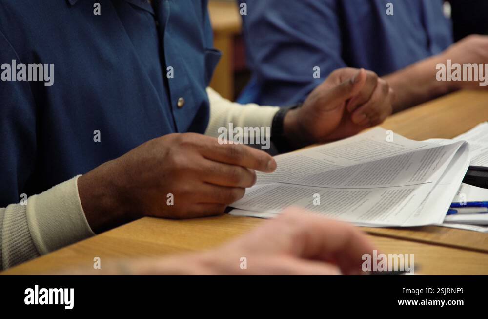close up african american with papers books in prison black inmate in ...