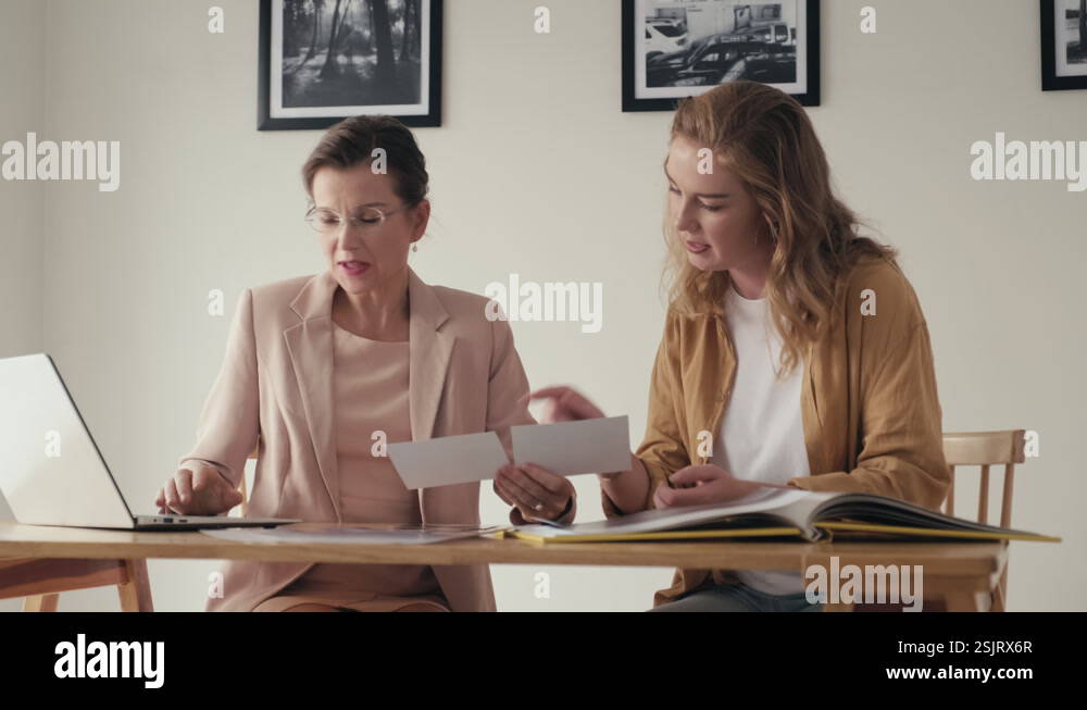 Female Artist and Gallery Curator Using Laptop and Choosing Photos ...