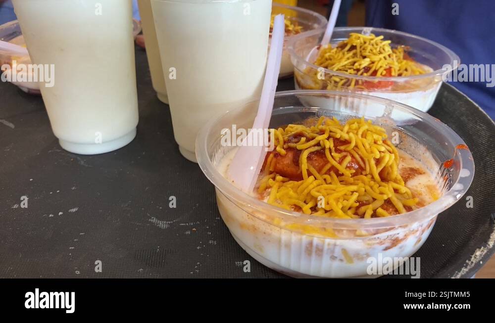 Traditional Indian Guajarati snack food dahi vada and lassi served ...