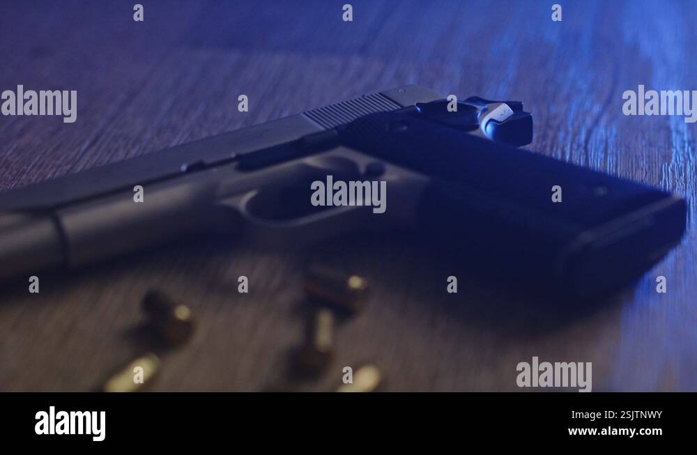 Dolly of a fired gun with spent bullet casings in a smoky crime scene ...
