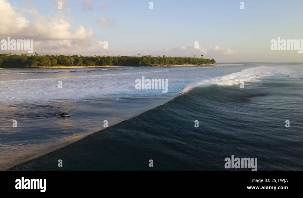 Huge ocean wave crashes into a surfer at G-Land, Grajagan Bay ...