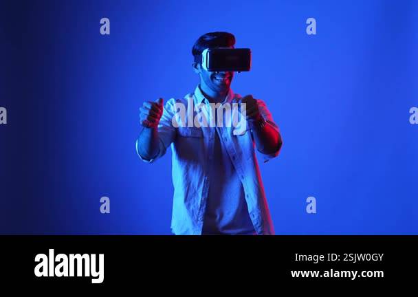 Professional gamer with casual cloth wearing VR goggle while driving ...