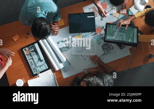 Top down of skilled business people holding tablet an looking at ...