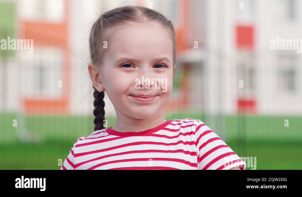 Portrait of little girl looking into camera. Little girl look, smiles ...