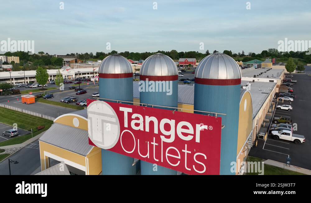 Tanger Outlets logo and sign on silos. Shopping center with many retail ...