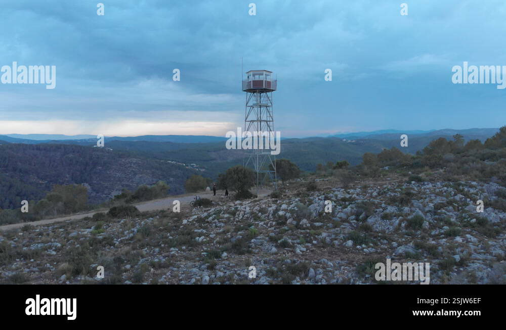 Watchtower on top of mountain captured in an aerial circling drone shot ...