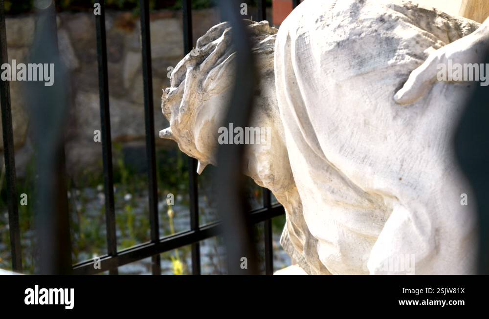 Statue of Jesus falling under the cross, station of the Cross in ...