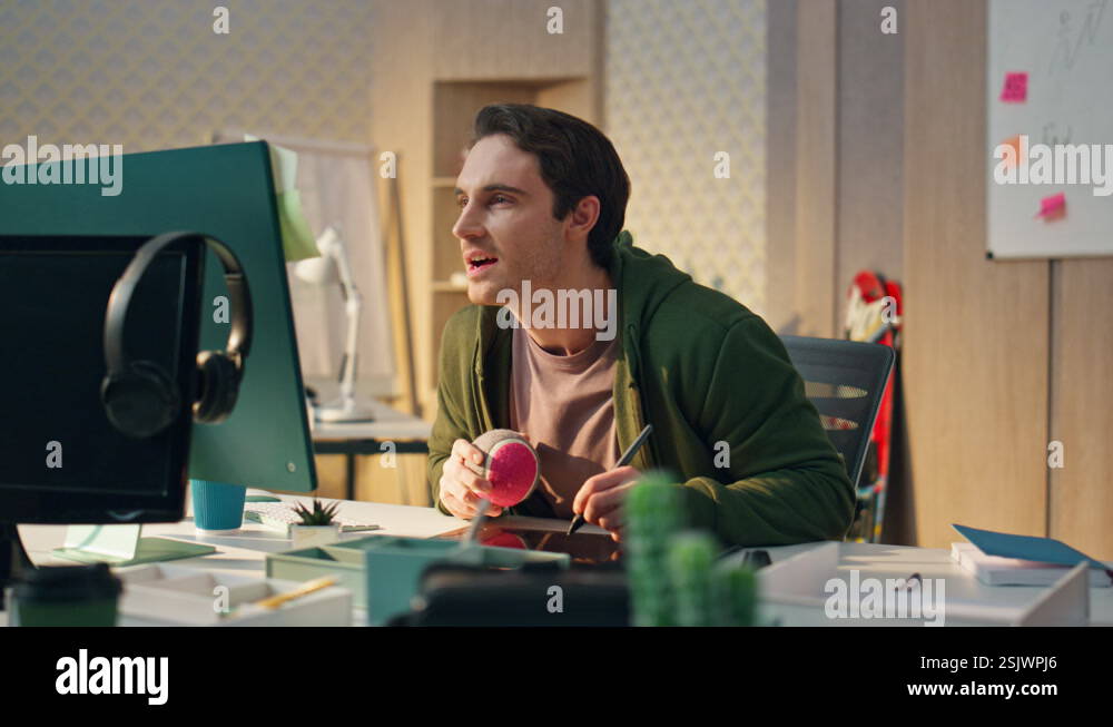 Relaxed guy looking computer screen at office. Talented artist drawing ...