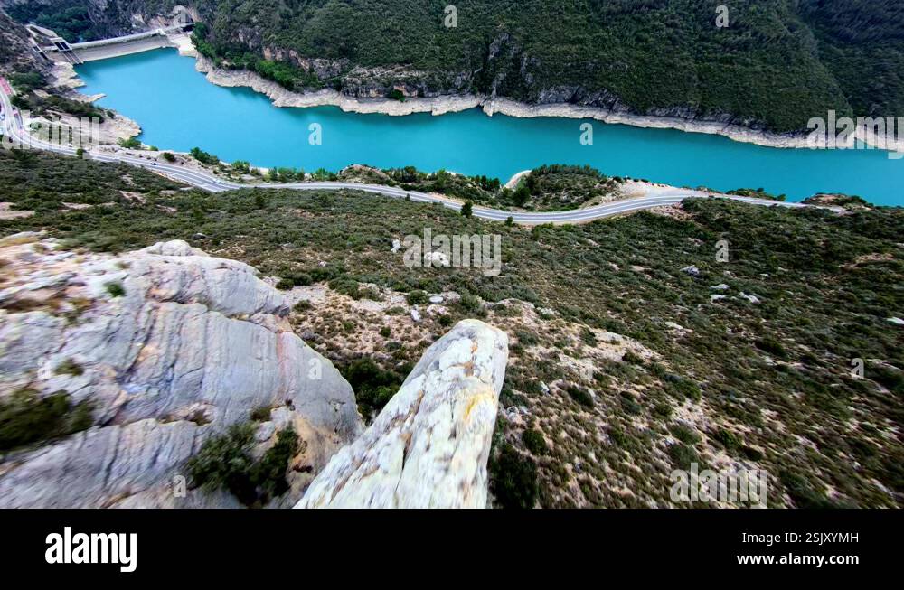 FPV Drone Cliff Dive Reveals Hydroelectric Dam Lake and Road in Spain ...