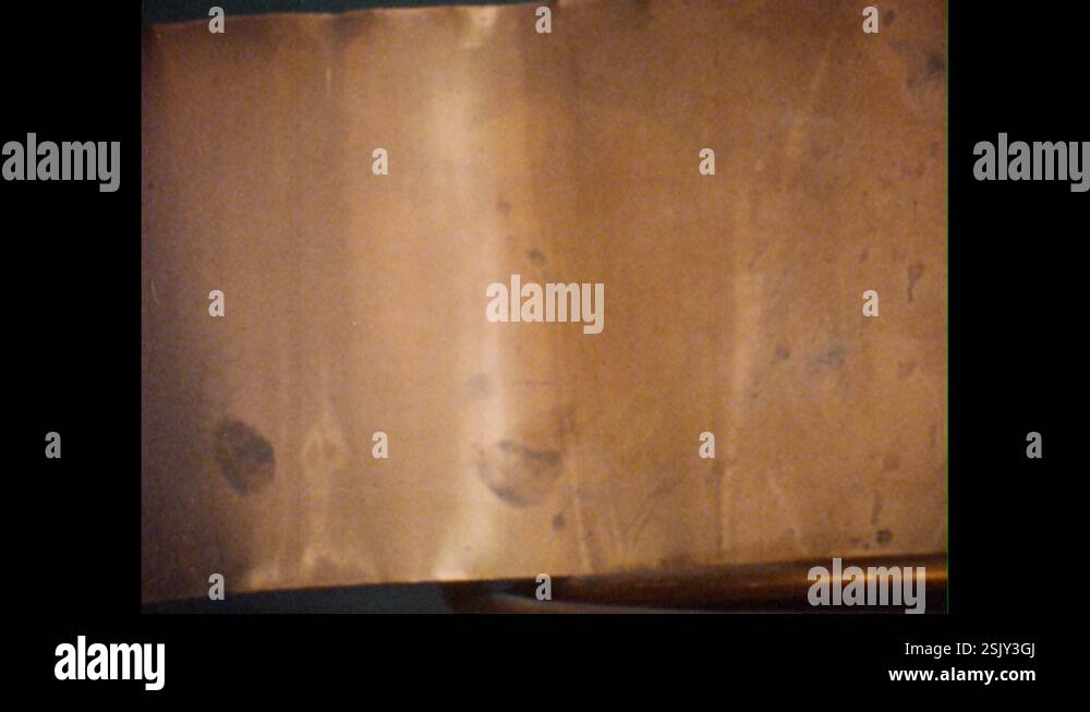 1980s: Electrons shine on drawing of nucleus. Band of copper and petri ...