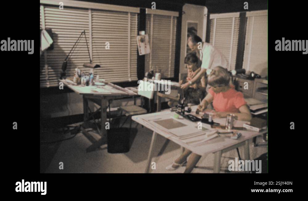 1960s: Close up of food label. People at drafting tables in office ...
