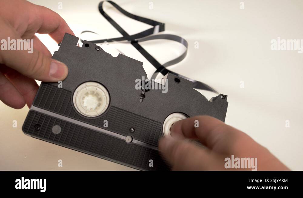 Manual rewinding of VHS tape onto the reel in the cassette Stock Video ...