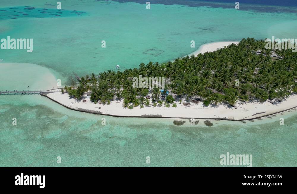 Aerial panoramic pan across onok island reveals pier and sandbar with ...