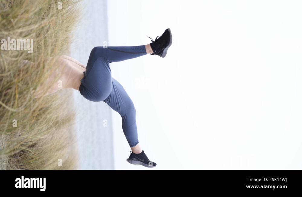 Vertical - Man On The Grass In Yoga Headstand Position With Stag Legs ...