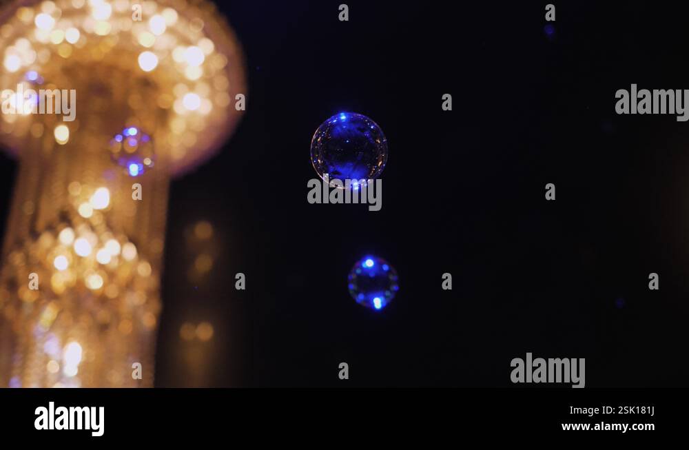 Tracking shot with soap balloon floating in the air at a party ...