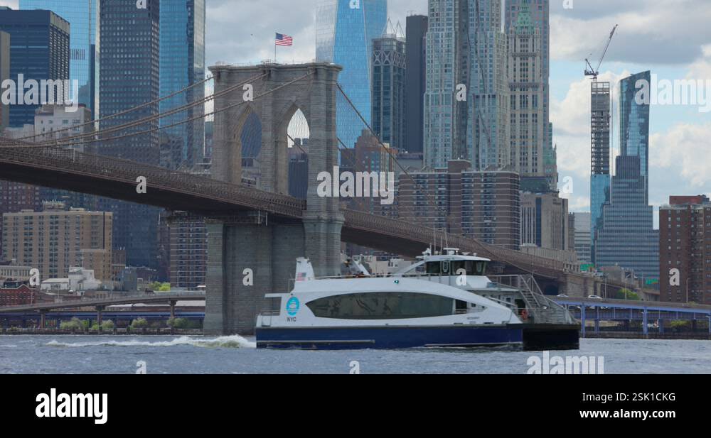 Ferry boat passing under New York Brooklyn Bridge. Low angle with Stock ...