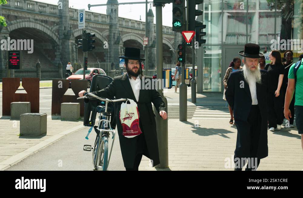 Orthodox Jewish men walking in the diverse multicultural Antwerp's ...