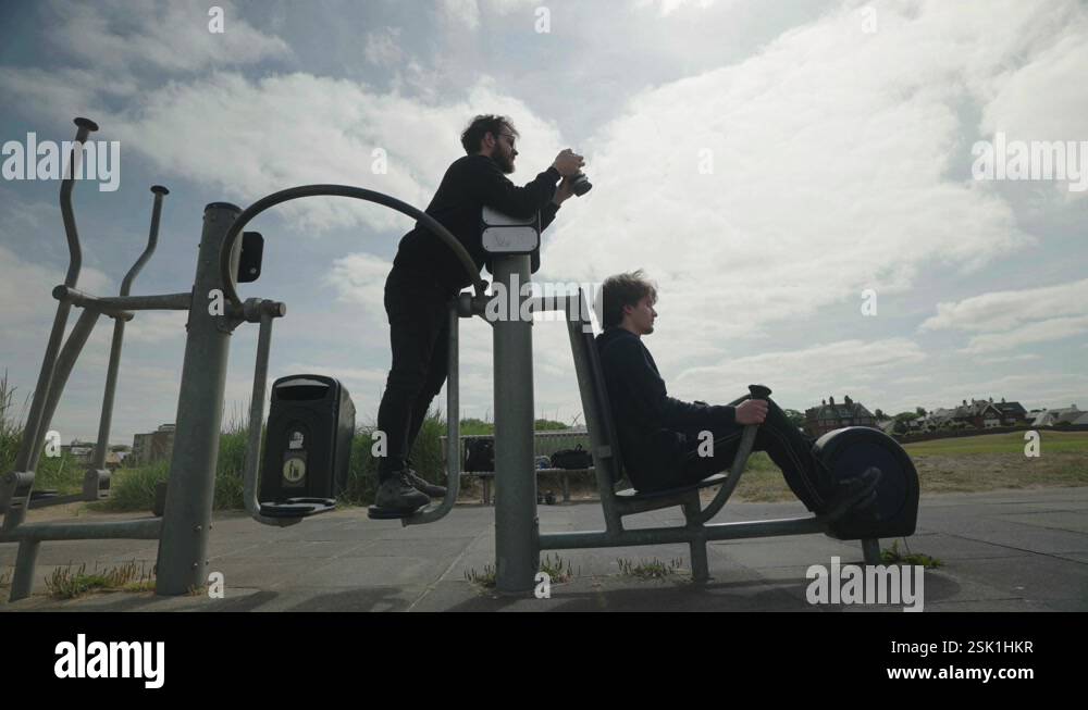 Videographer captures overhead footage of man on exercise bike outdoors ...