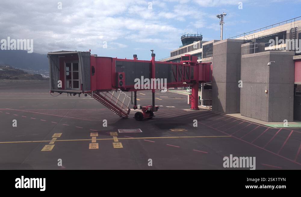 passenger boarding bridge jet bridge moving away from plane in La Palma ...