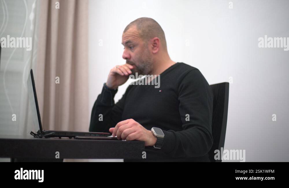 a man working with his computer at home looking surprised Stock Video ...