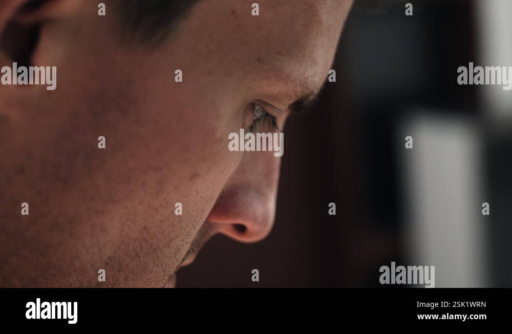 Closeup of face of man, prison inmate in prison cell. A sad, depressed ...