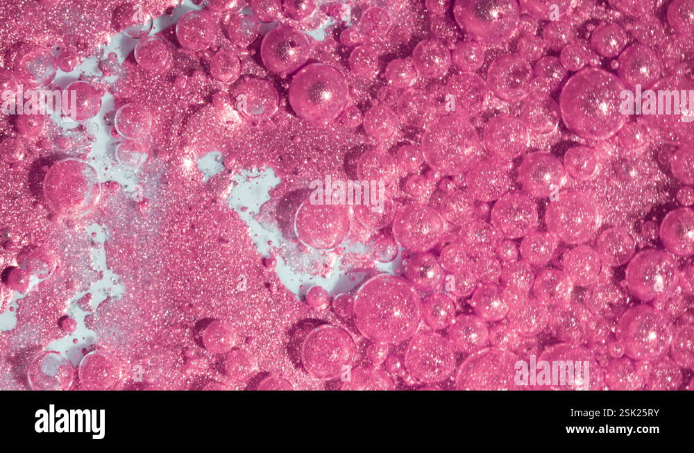 Mixing oil and pink pearl paint forms beautiful texture.Golden pearls ...