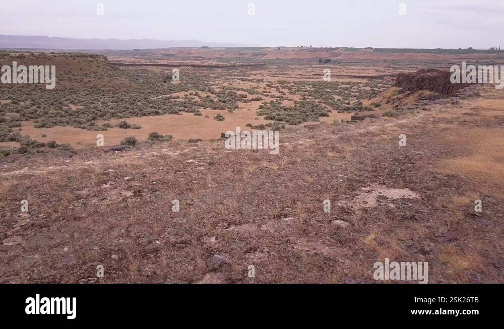 Flyover Scablands sagebrush plateau and over tall rock column cliffs ...