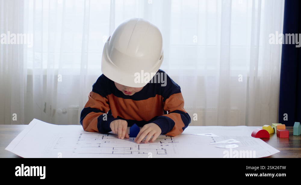 Preschooler pretends to be engineer and points to drawing Stock Video ...