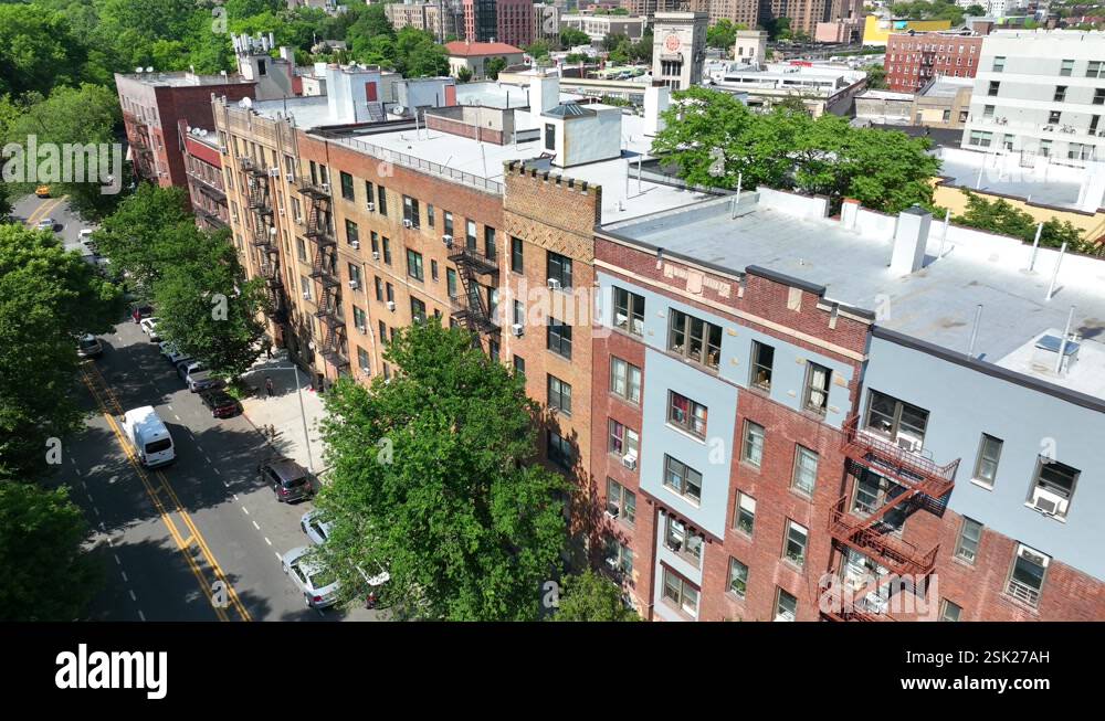 Rundown apartment buildings in New York City. Green trees in summer ...