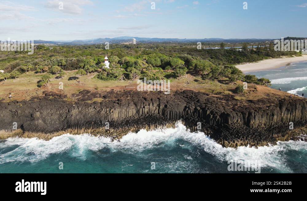 Scenic view of the Fingal Heads lighthouse and the towering basalt rock ...