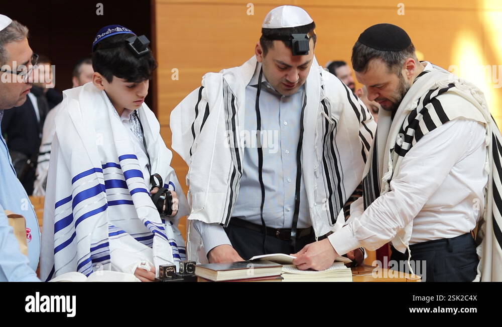 Focus on printed edition reading religious text. Beginning bar mitzvah ...