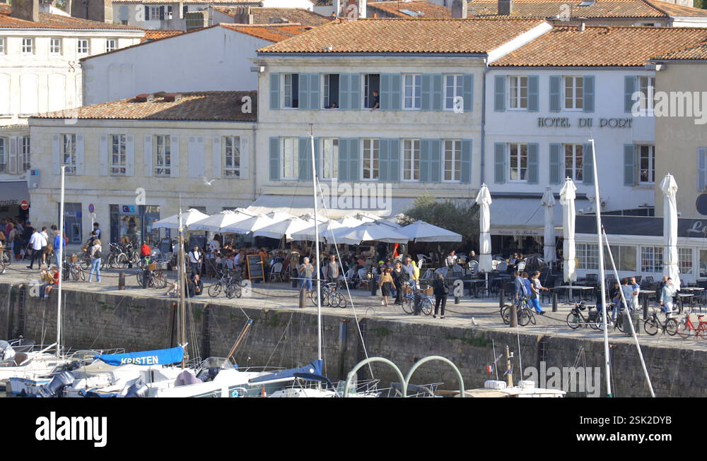 Crowd of tourists walking on the quays of the port of Saint-Martin-de ...