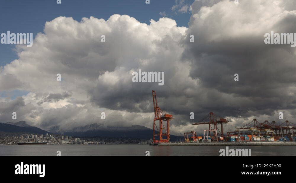 Container ship loading docks with crane empty on cloudy day - wide shot ...
