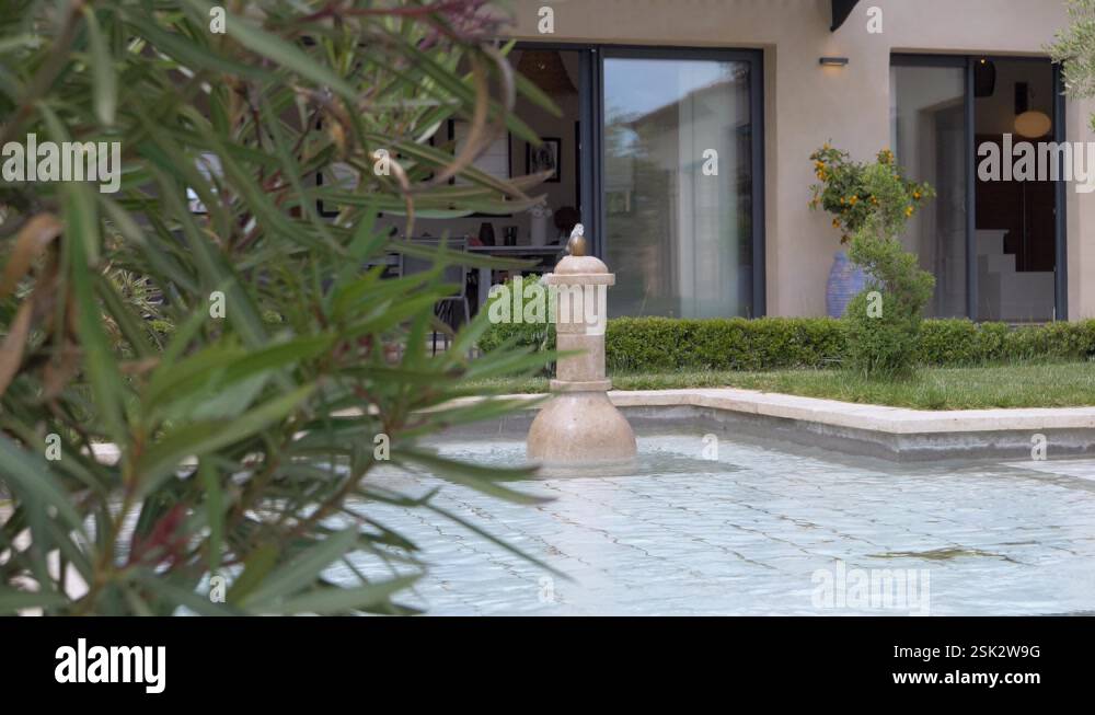 Amidst the lush green shrubbery, there stands a house with a pool ...