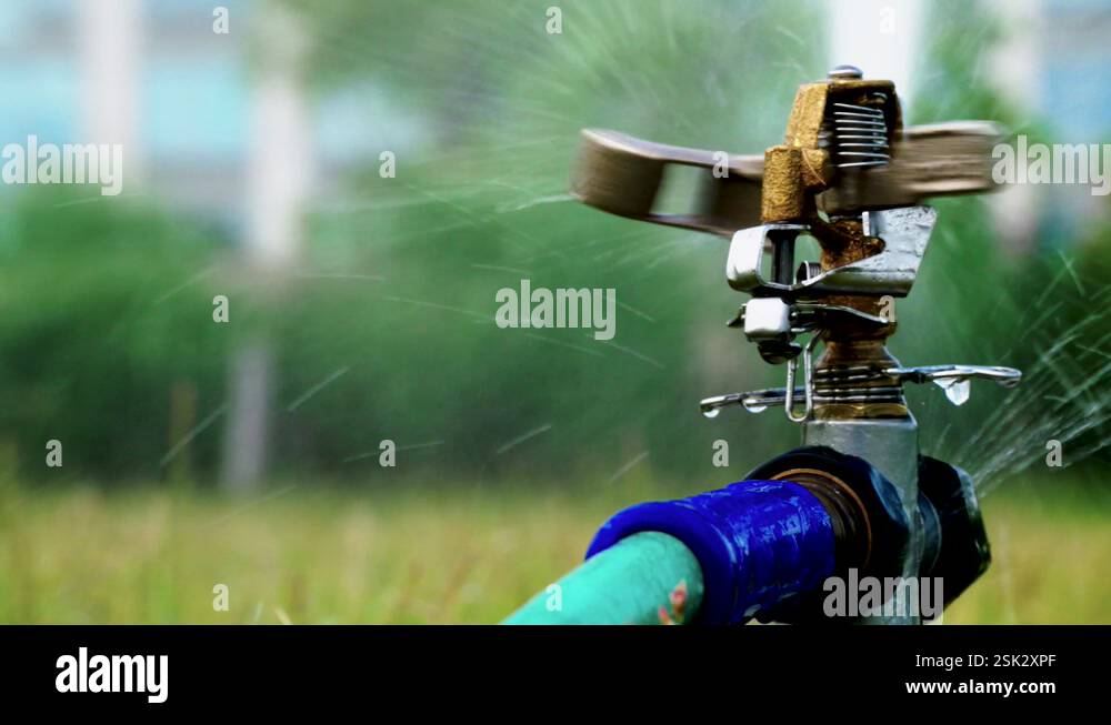 Pulsating Sprinkler, tight shot, sprinkler moves slowly to the right ...