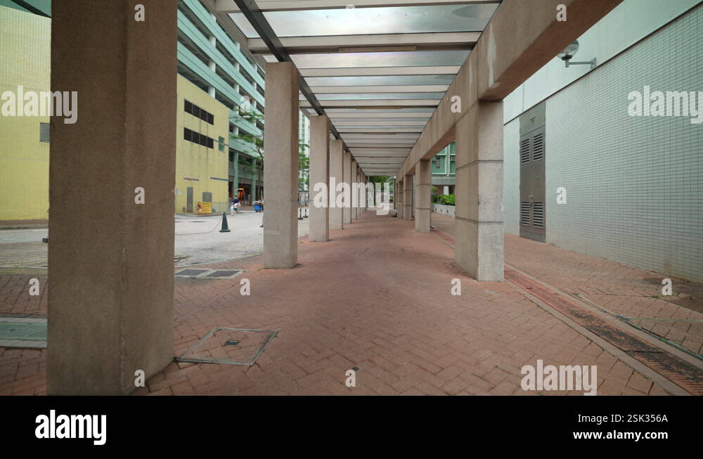 Huge concrete material empty corridor with many columns and residential ...