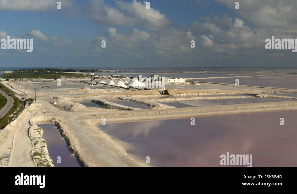 Pink salt evaporation ponds and salt mounds in sea saltern in Mexico ...