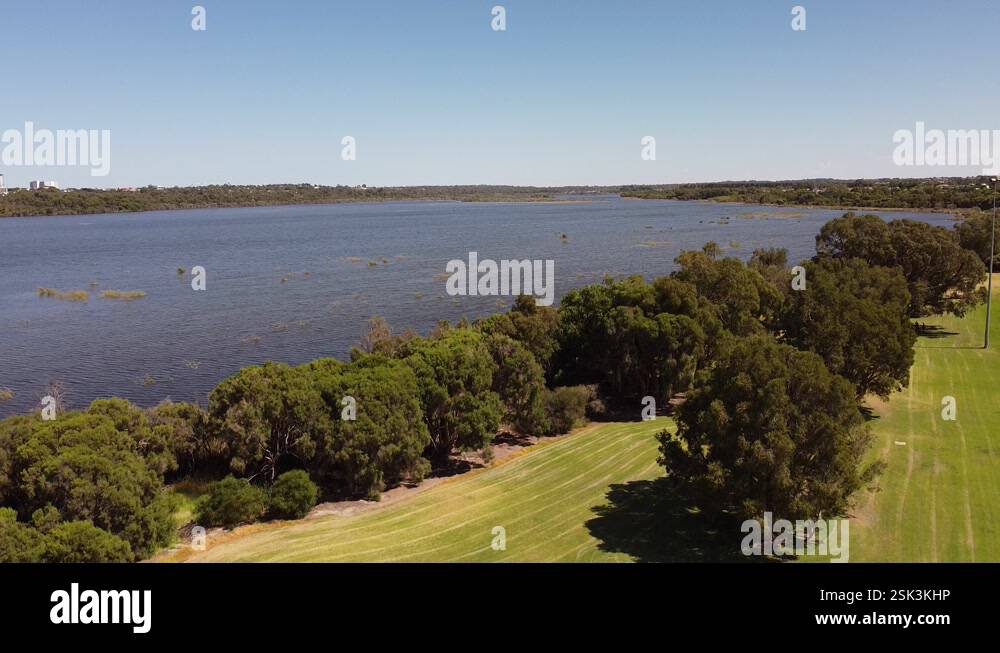 Crane shot of Lake Joondalup, the trees and fields of Rotary Park ...