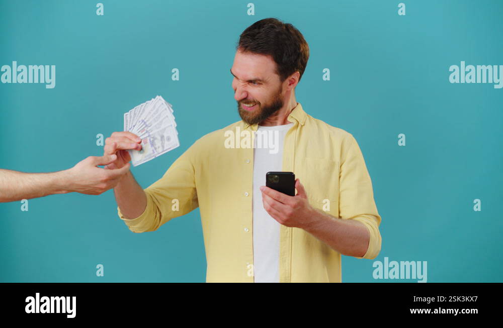 Rich man receives money working at phone and throws bills up Stock ...