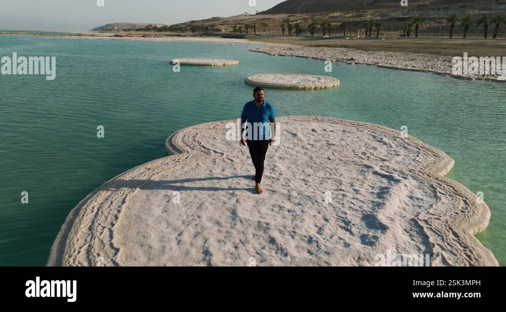 Adult Man Walking Barefoot On Salt Formation At The Dead Sea During ...