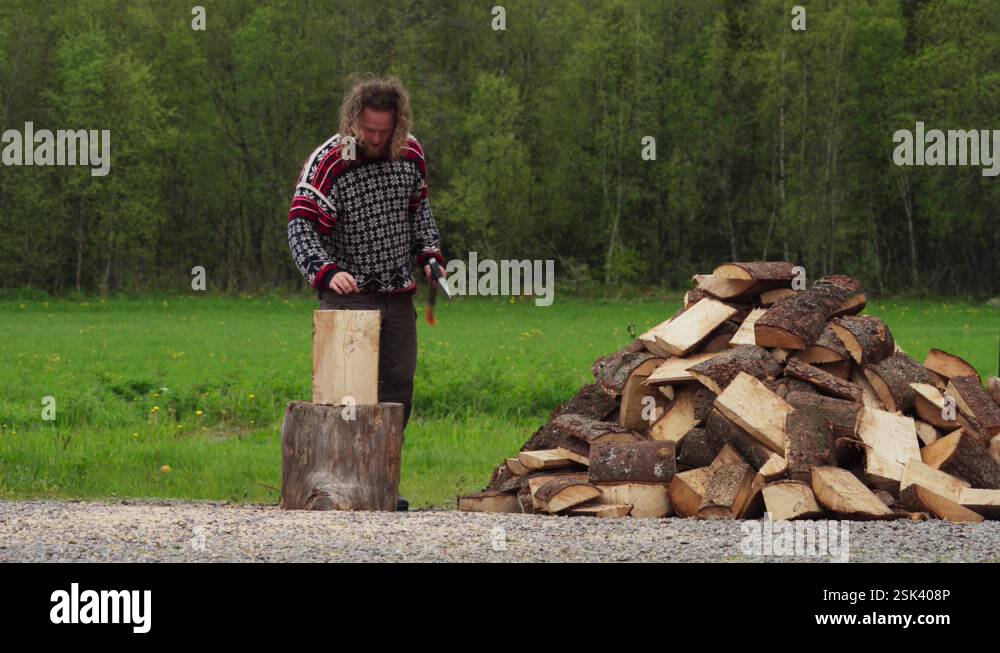 Man Chopping Logs With An Ax Outdoors - wide Stock Video Footage - Alamy